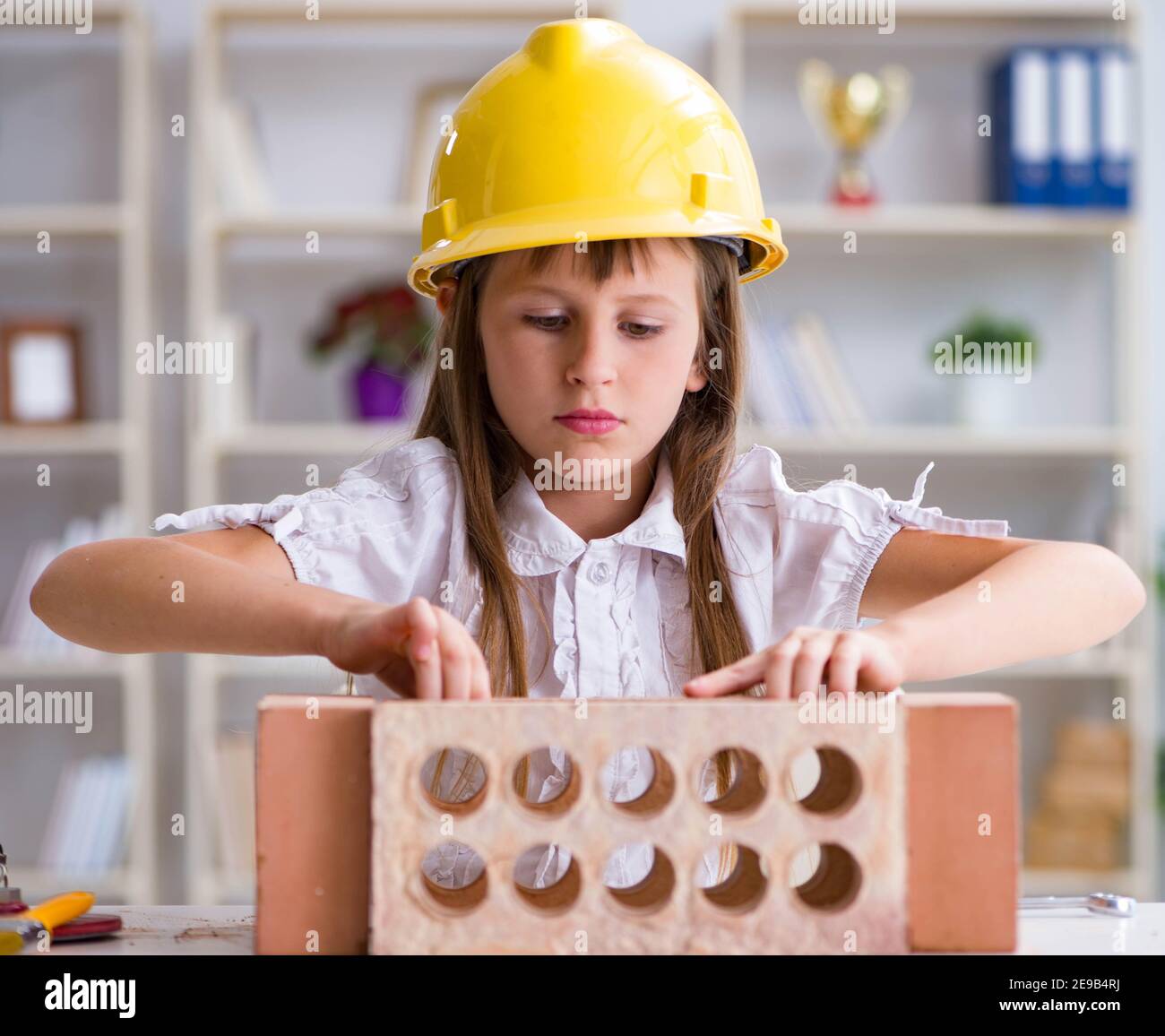 The young girl building with construction bricks Stock Photo - Alamy