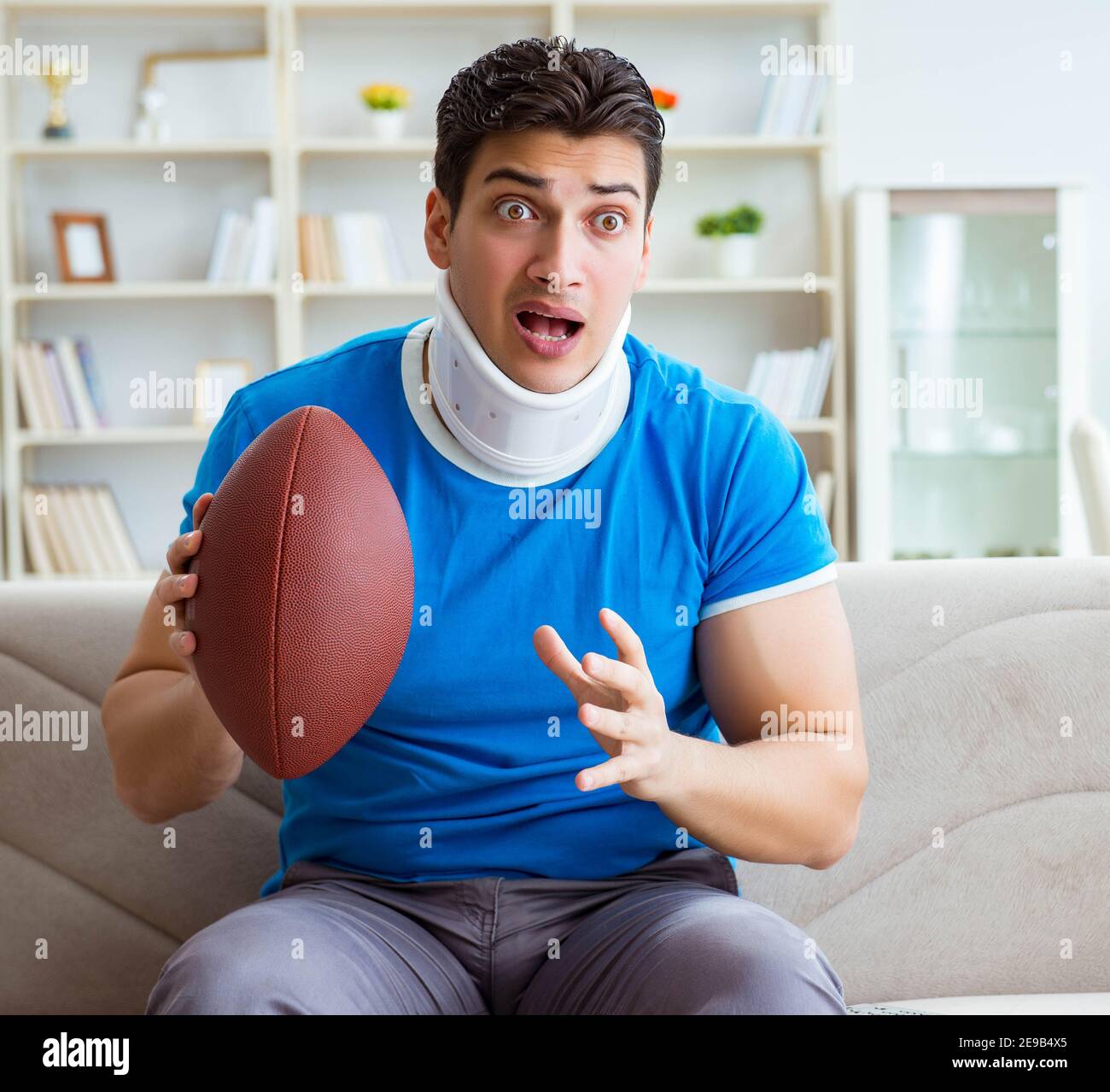 The man with neck injury watching american football at home Stock Photo ...