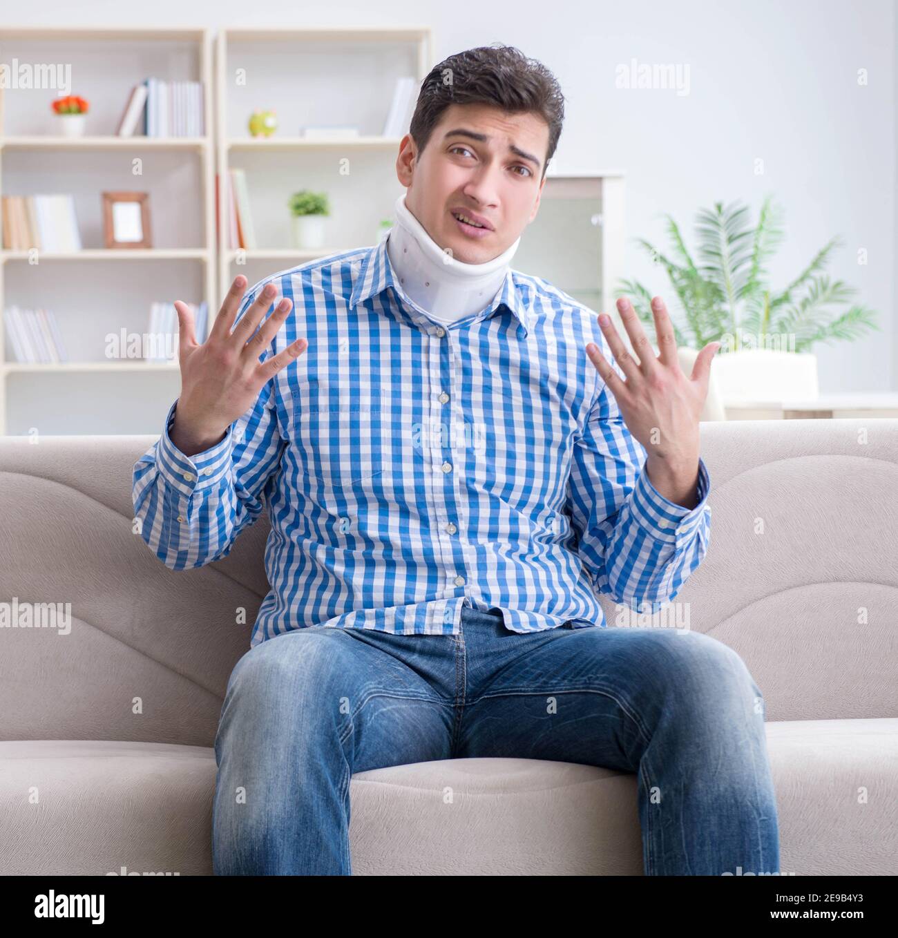 Young man suffering a neck spine head trauma wearing a cervical collar ...