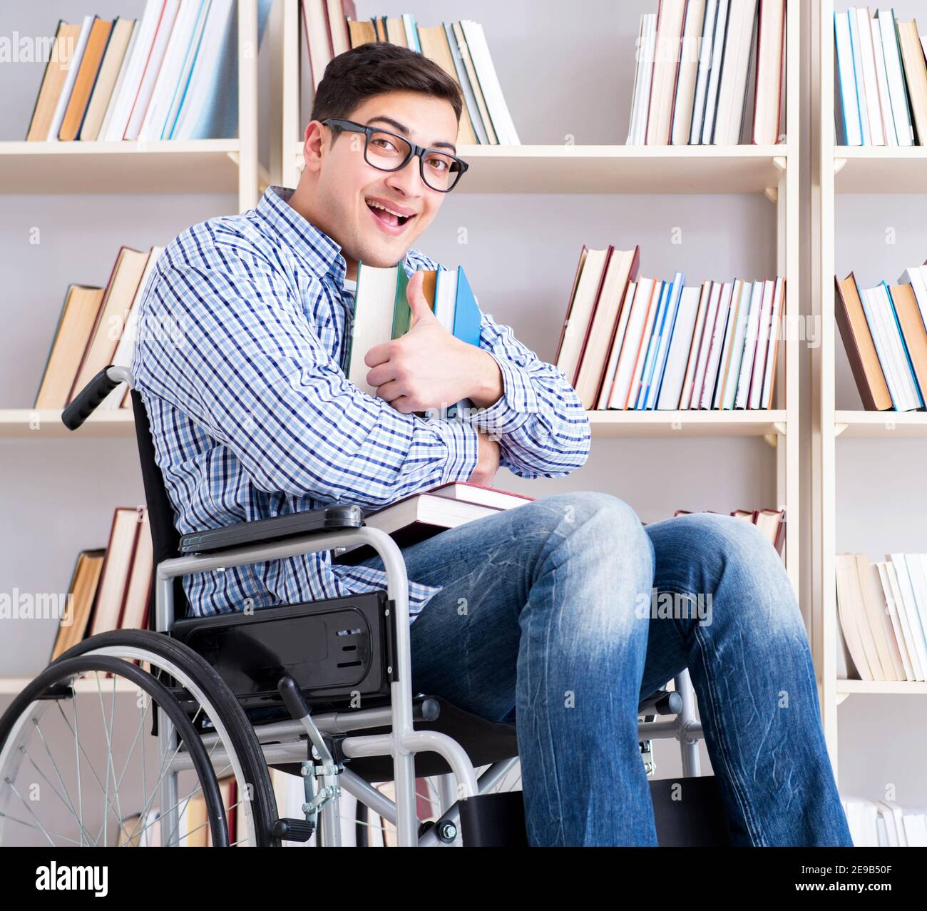 The disabled student studying in the library Stock Photo - Alamy