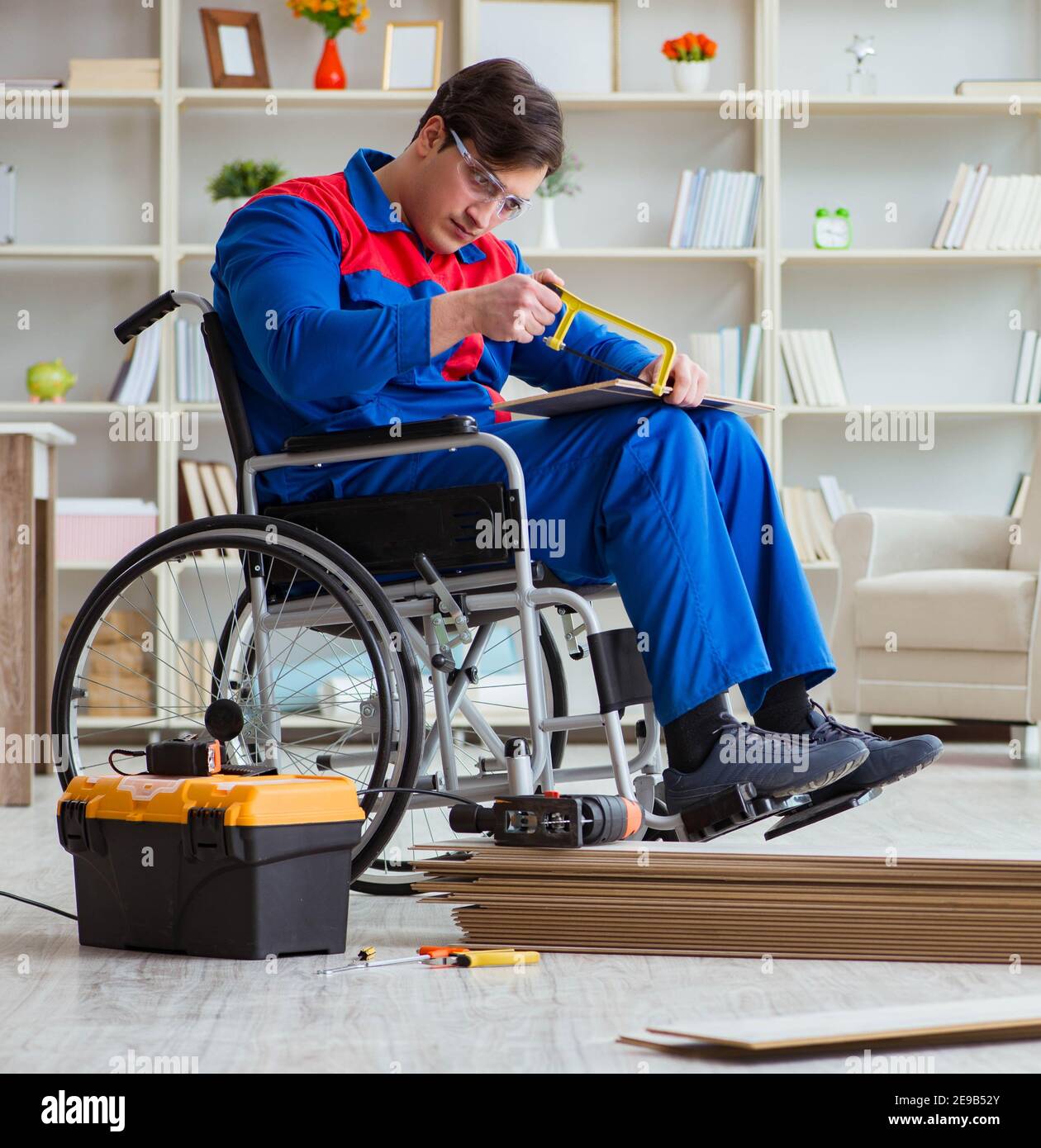 The disabled man laying floor laminate in office Stock Photo - Alamy