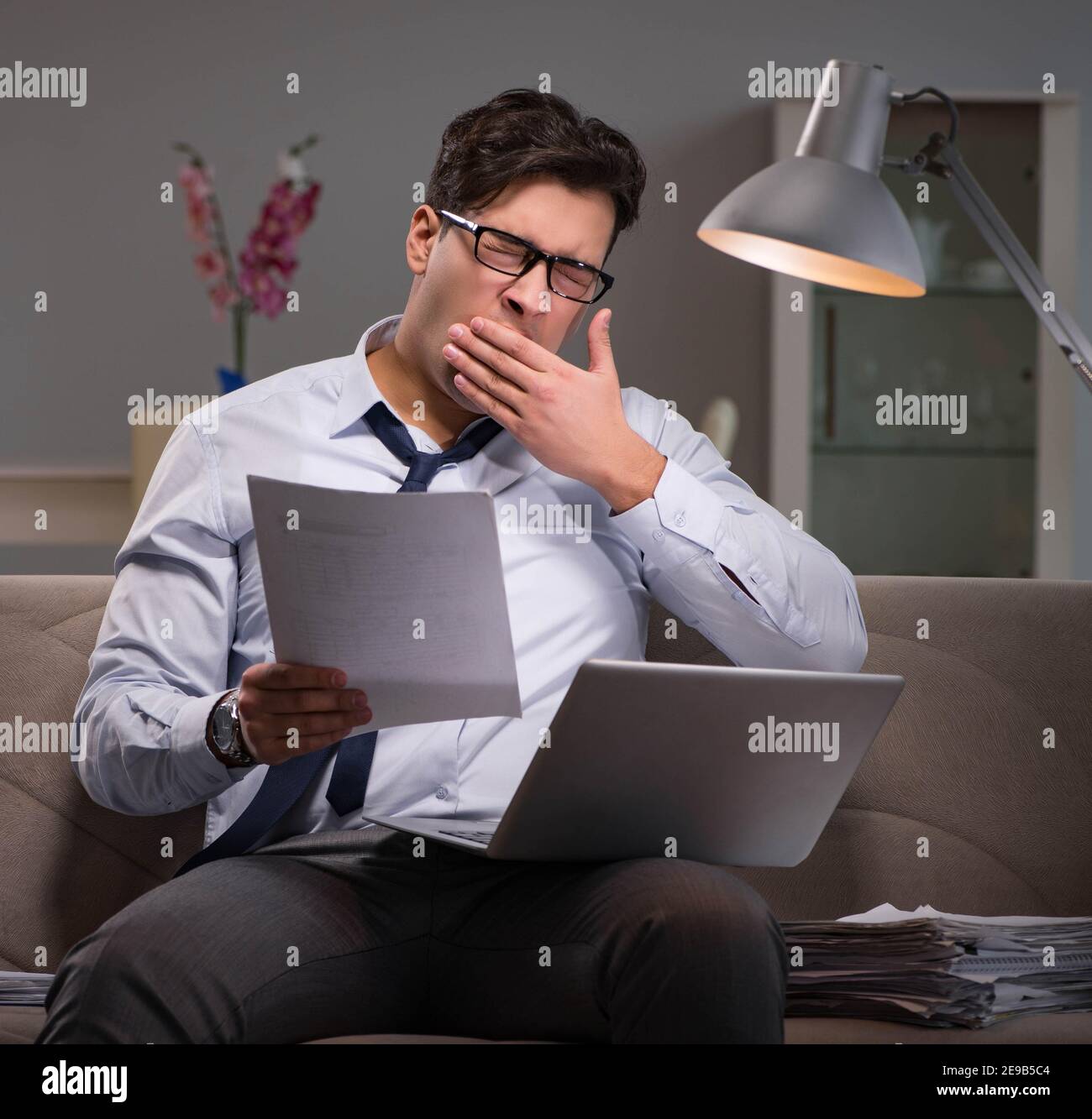 The businessman workaholic working late at home Stock Photo - Alamy