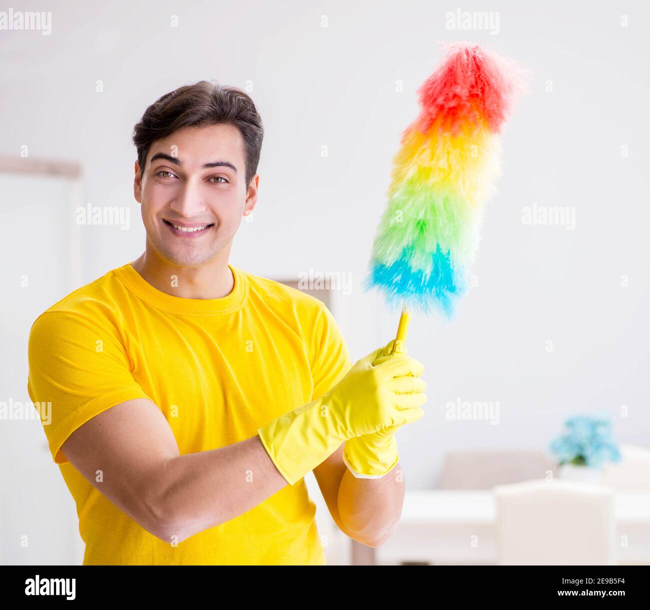 The man cleaning the house helping his wife Stock Photo - Alamy