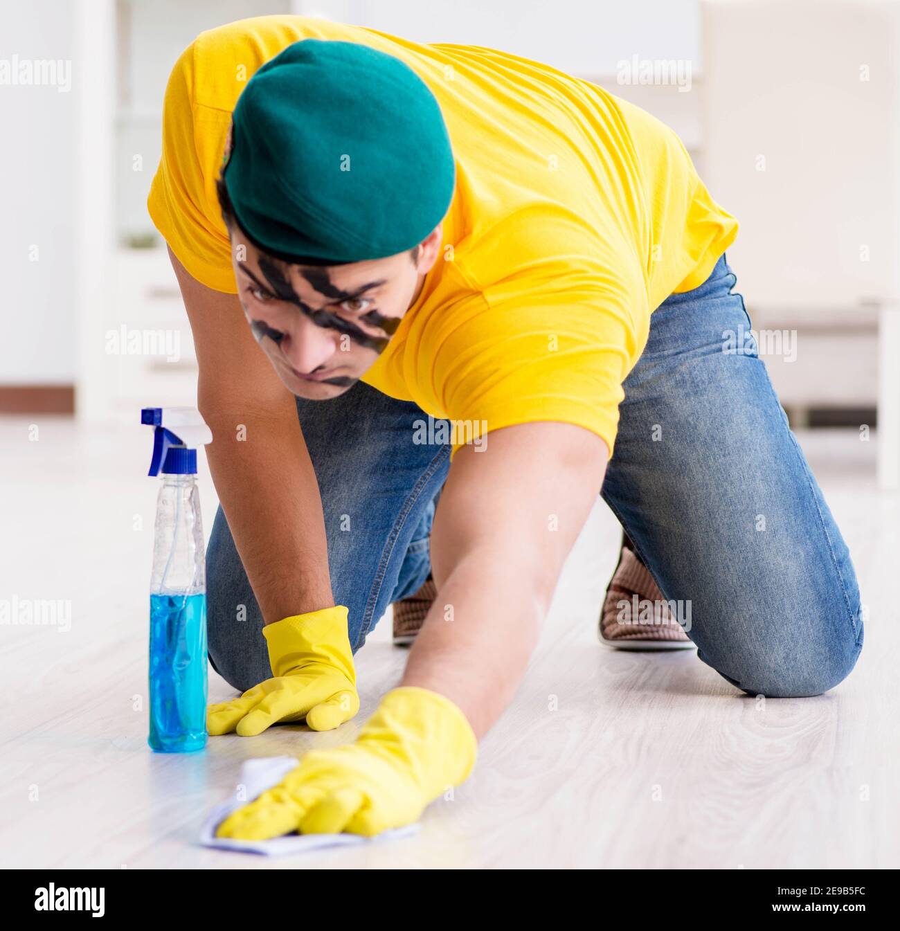 The man in military style cleaning the house Stock Photo - Alamy