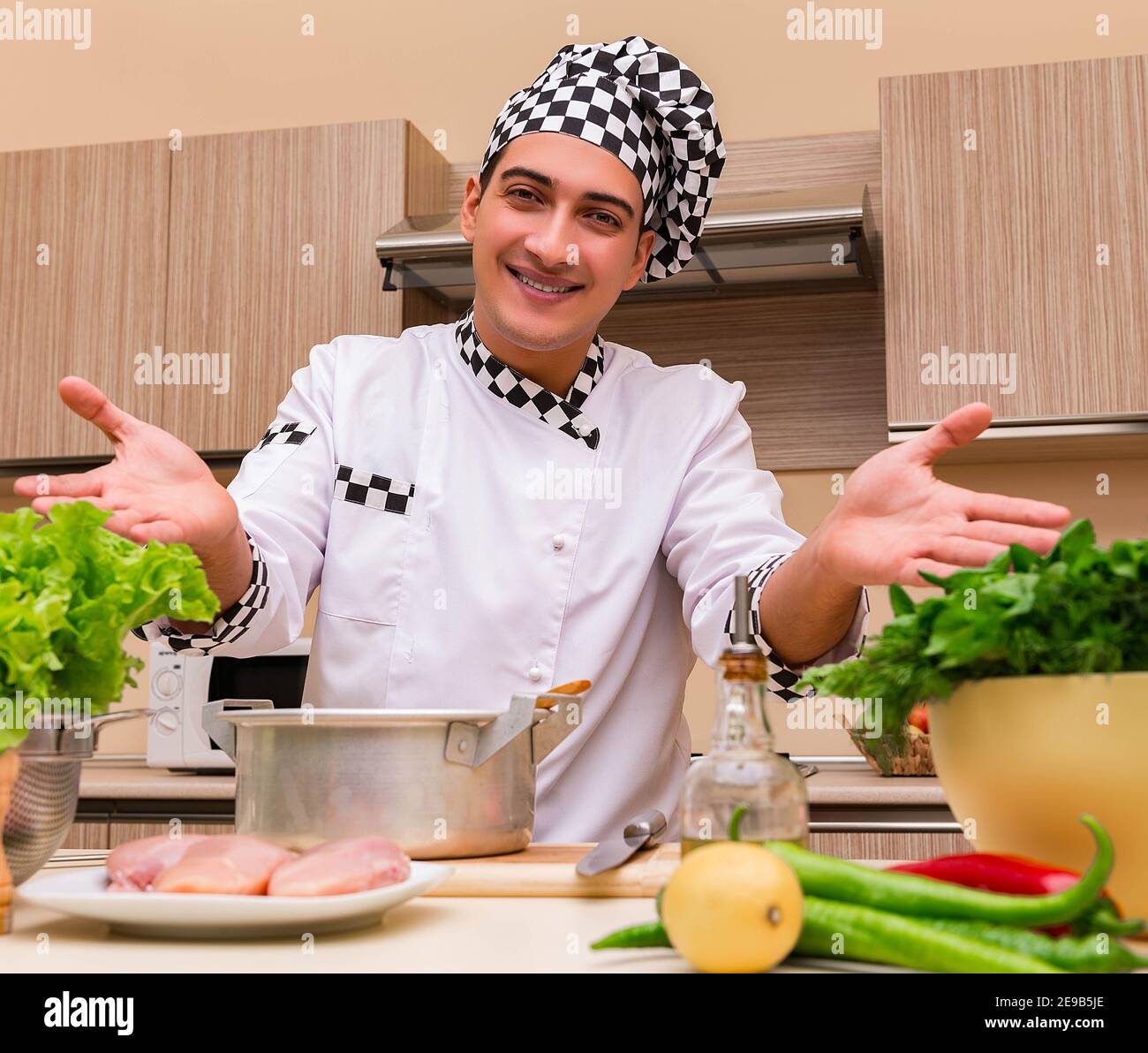 The young chef working in the kitchen Stock Photo - Alamy