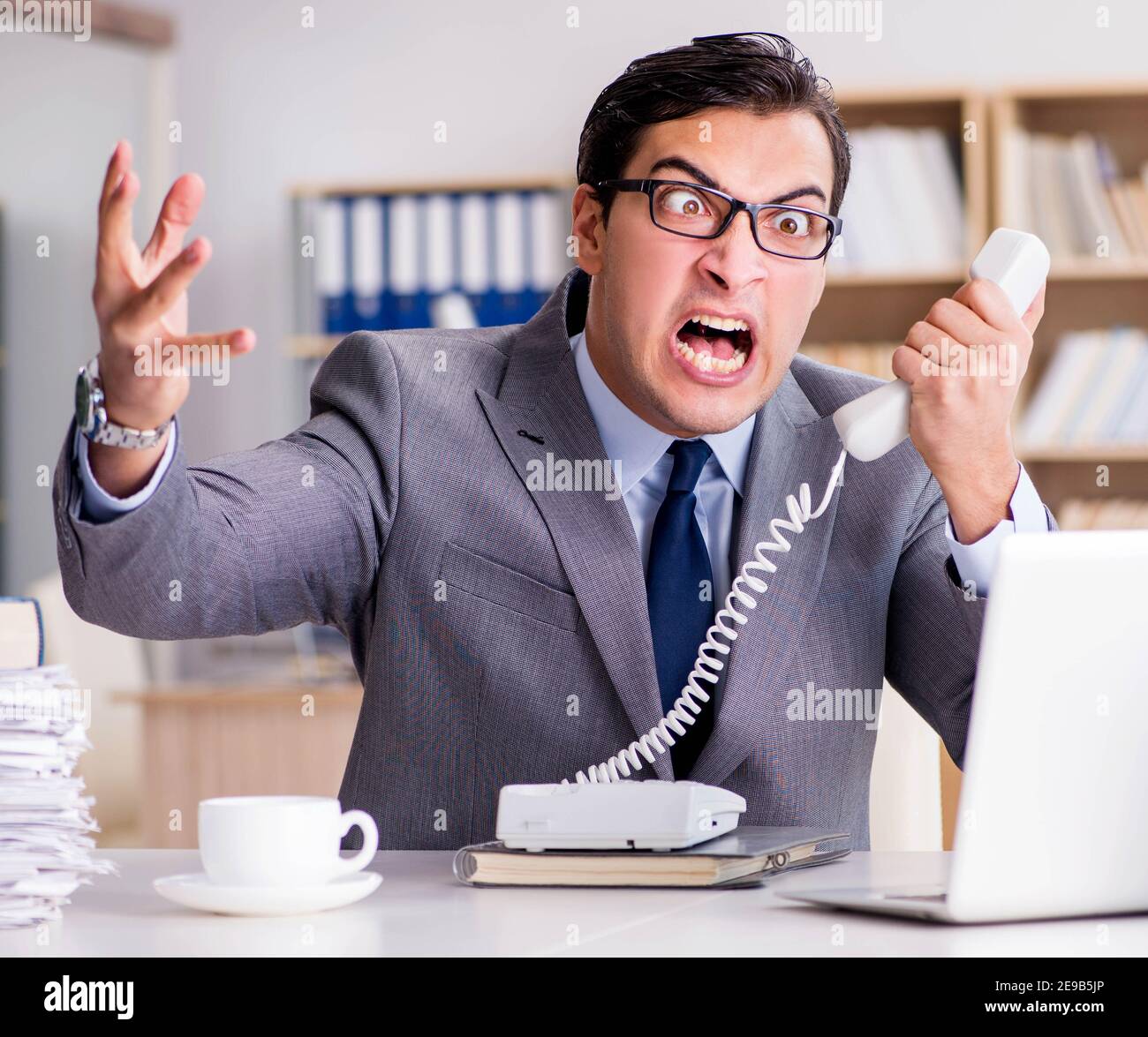 The angry businessman with too much work in office Stock Photo - Alamy