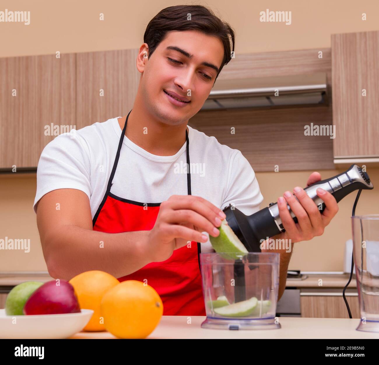 The handsome man working at the kitchen Stock Photo - Alamy