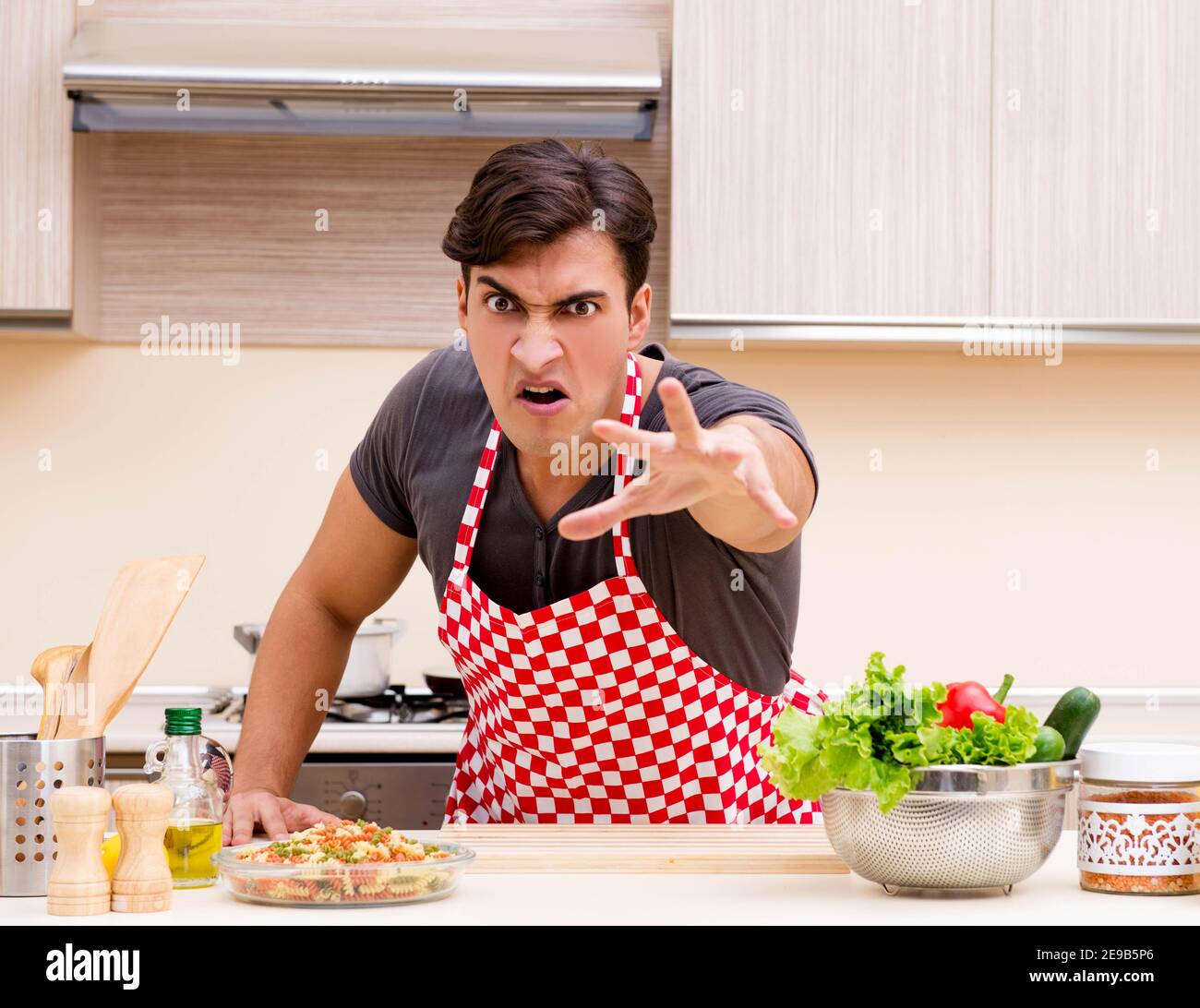 The man male cook preparing food in kitchen Stock Photo - Alamy