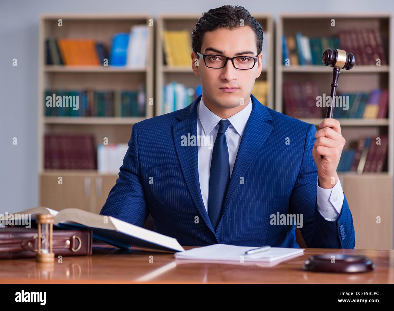 The handsome judge with gavel sitting in courtroom Stock Photo - Alamy