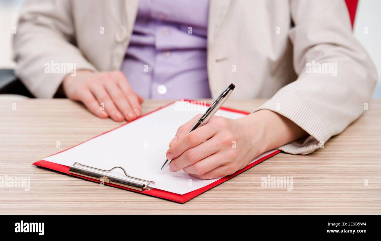 The hands taking notes in the pad Stock Photo - Alamy
