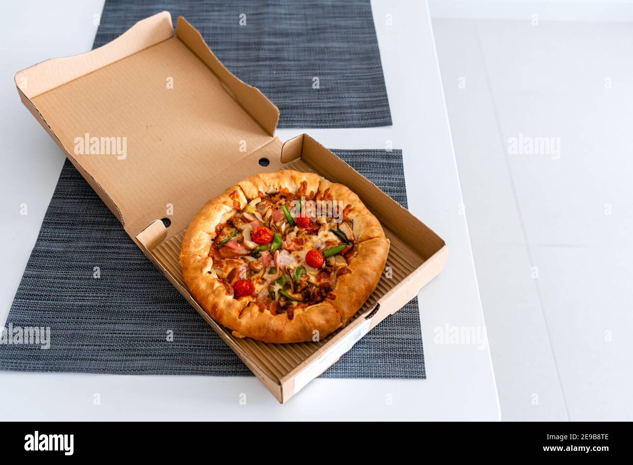 Pizza for one person. Mini pizza in a box. Food delivery Stock Photo ...