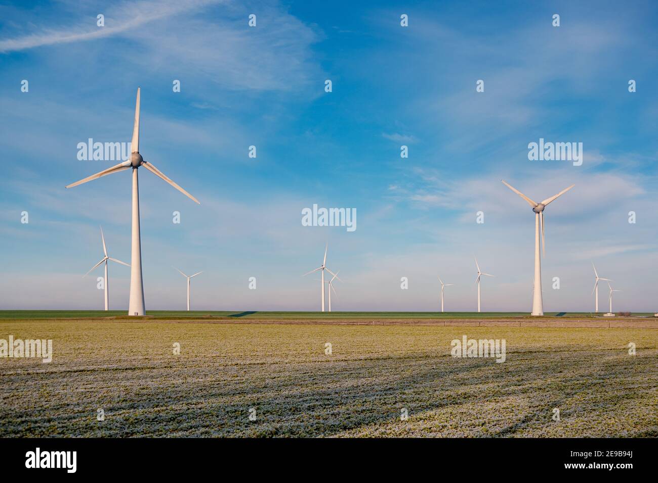 offshore windmill park with stormy clouds and a blue sky, windmill park ...