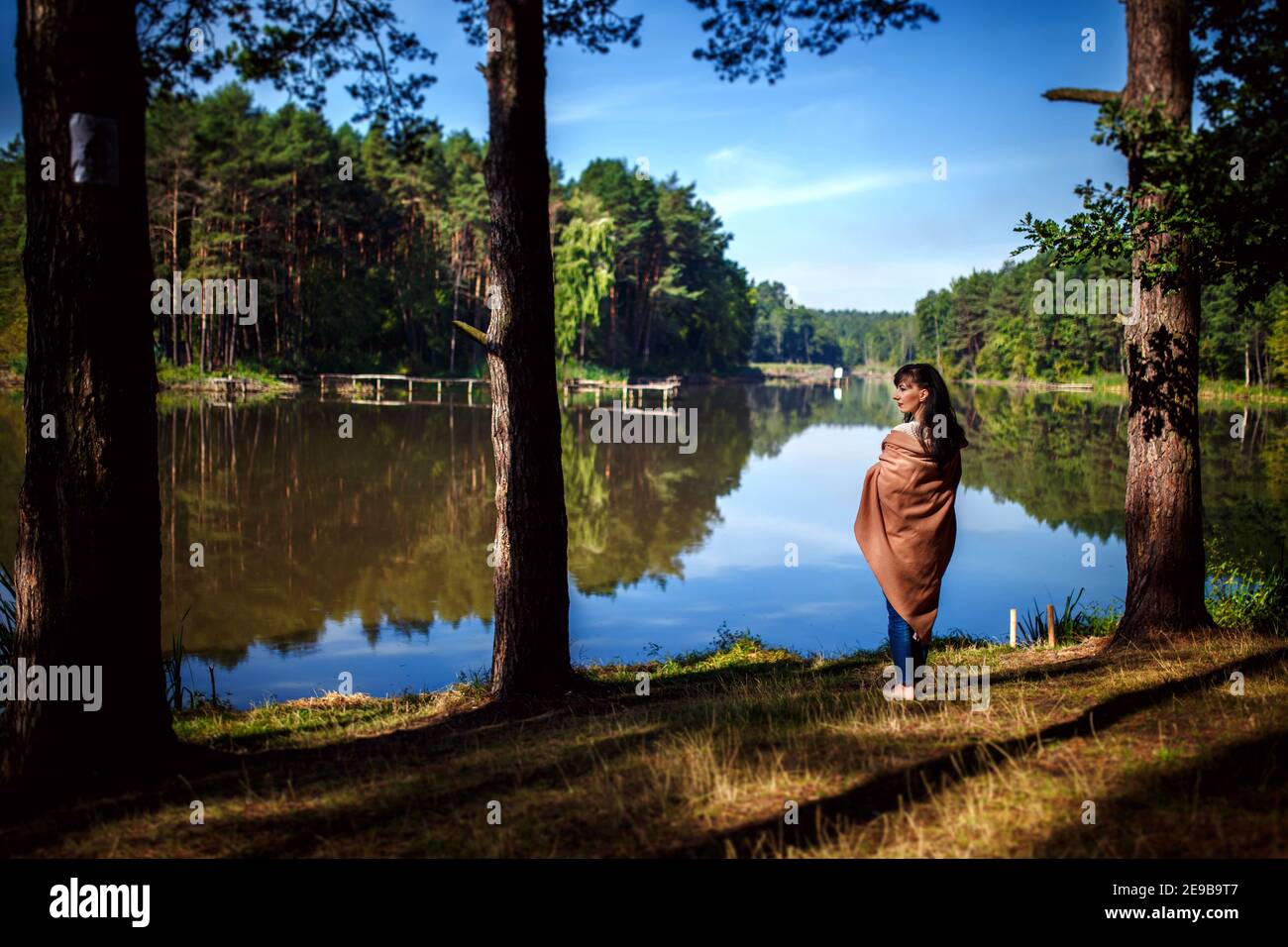 Girl posing against the backdrop of a lake or river. walk in nature ...