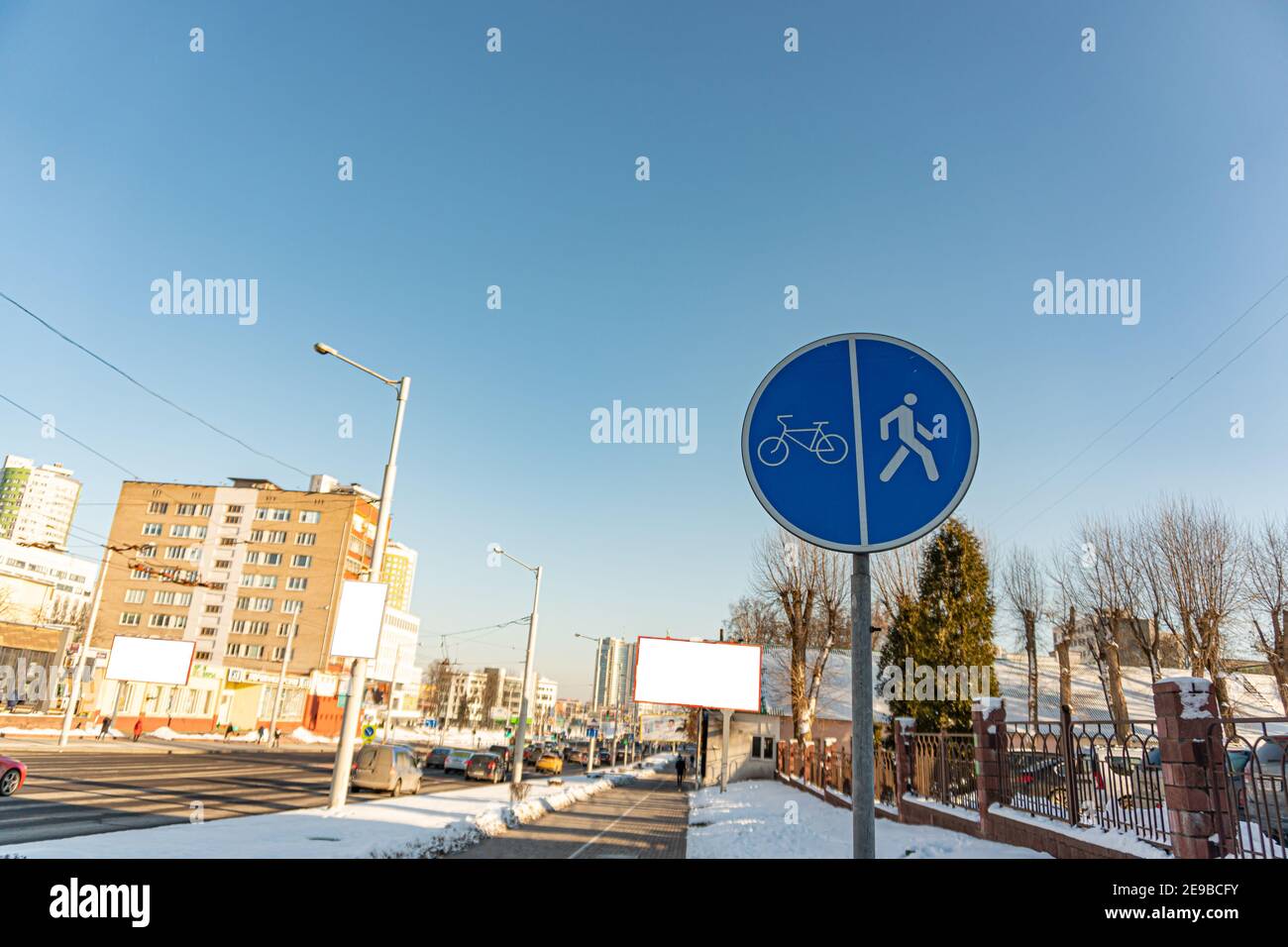 A sign that divides the path for pedestrians and bicyclists. Round blue ...