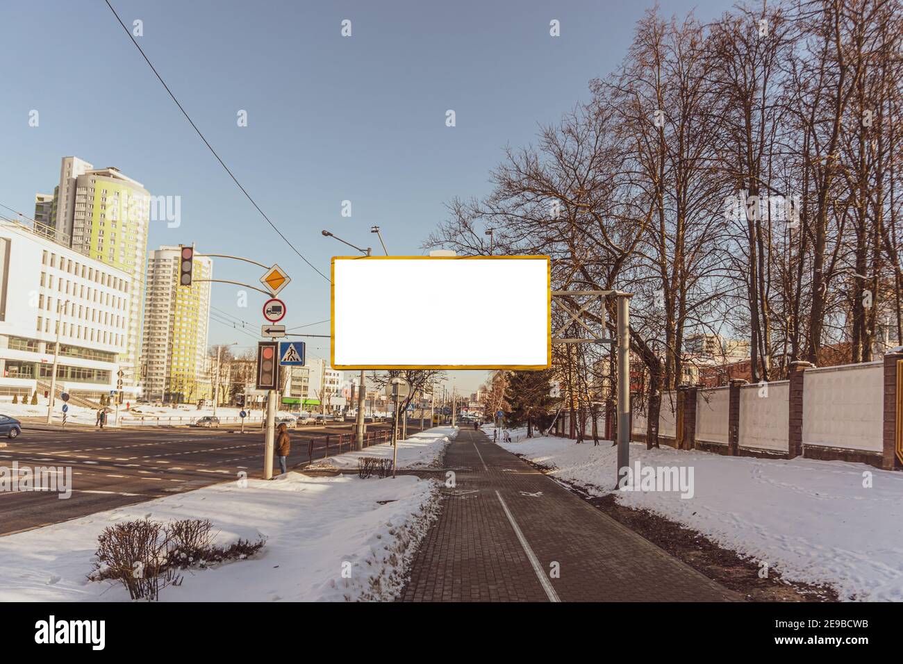 A billboard over a pedestrian street and bicycle path in the city Stock ...