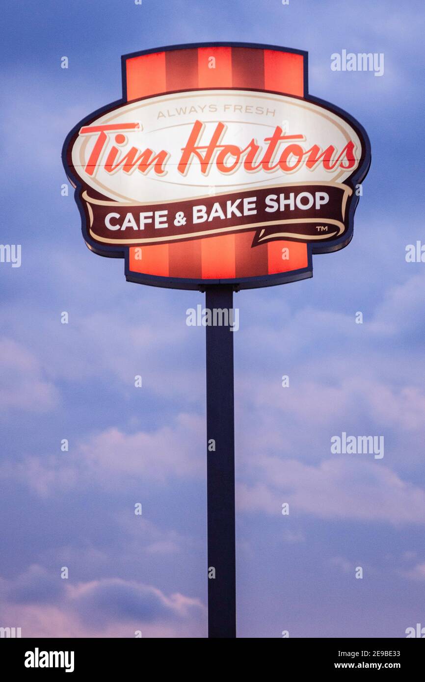 Tim Hortons sign and logo seen during sunset. (Photo by Stephen Zenner ...