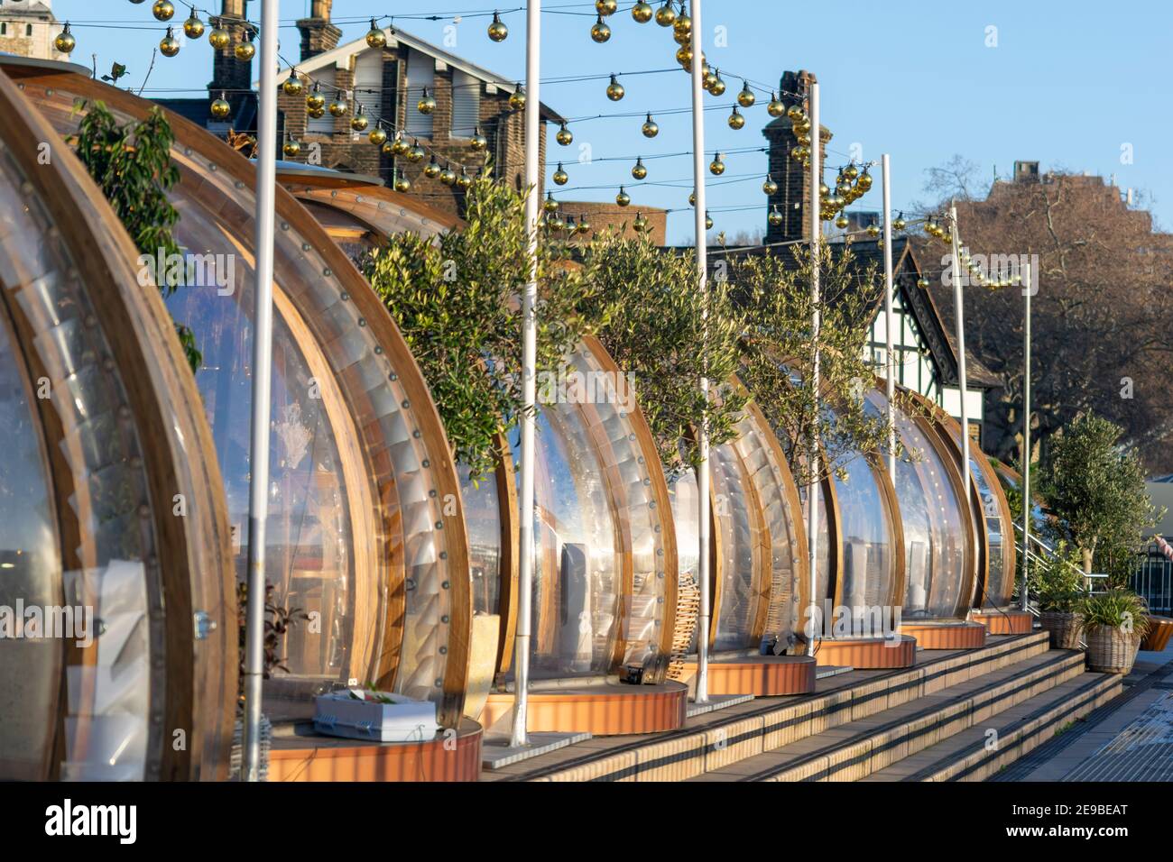 London, UK- 15 Dec 2020: Restaurant outdoor igloos, many separated ...