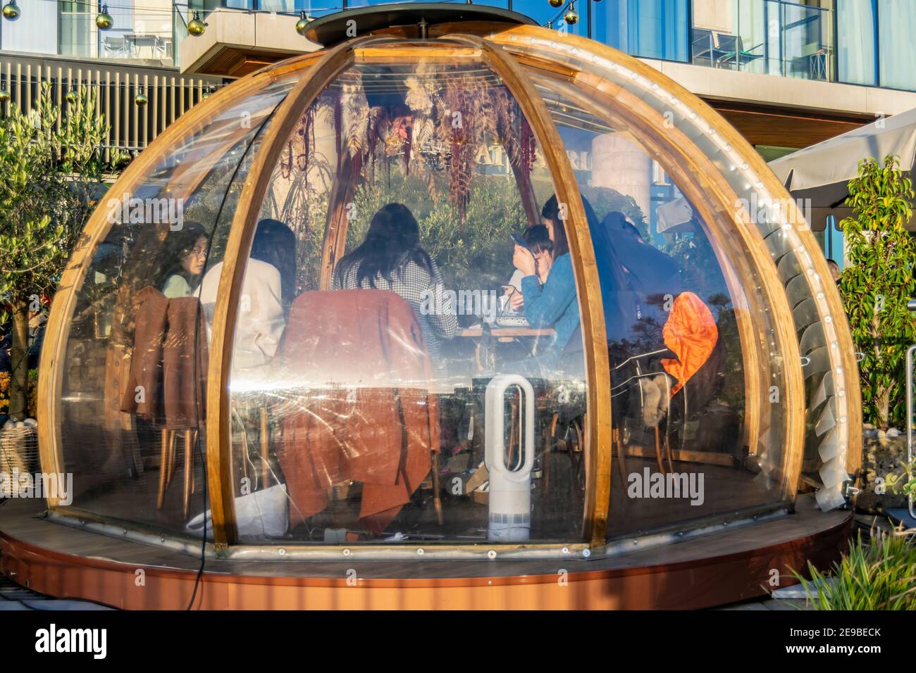 London, UK- 15 Dec 2020: Restaurant outdoor igloo separated serving ...