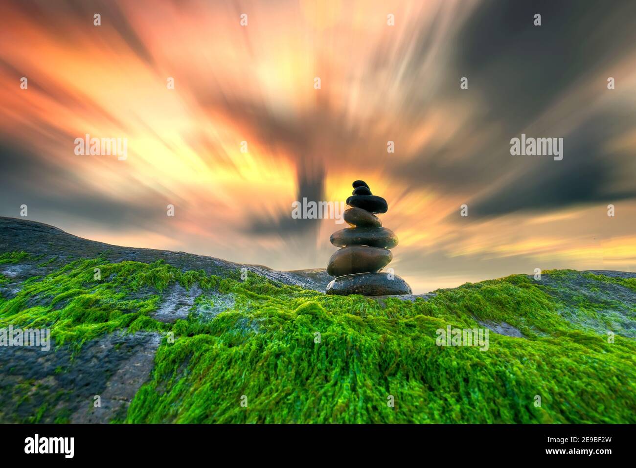 Stacked Pebbles art on mossy rocks welcomes beautiful new day Stock ...