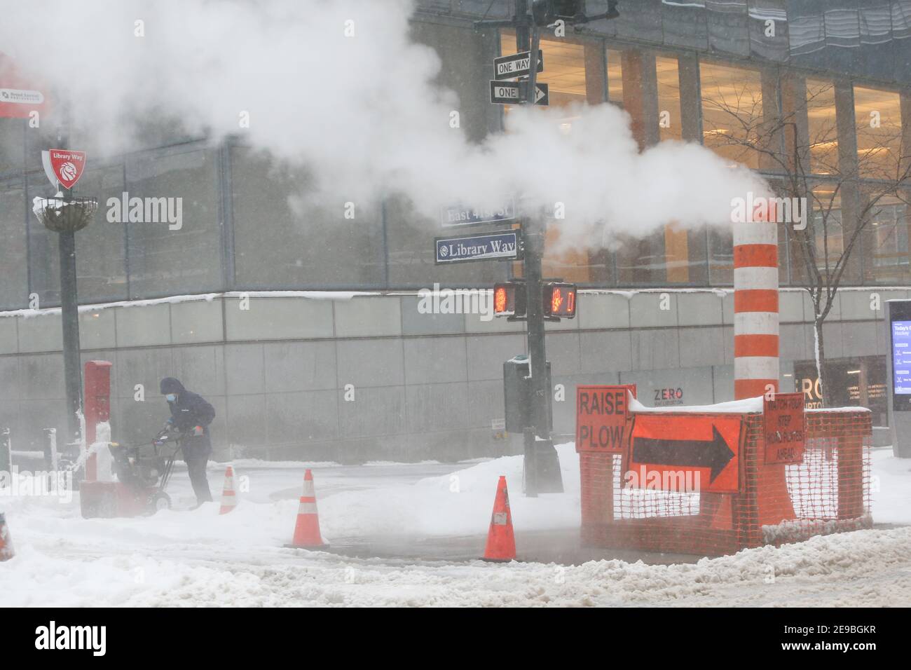 A worker with a snow thrower and a New York Steam Pipe Stock Photo - Alamy