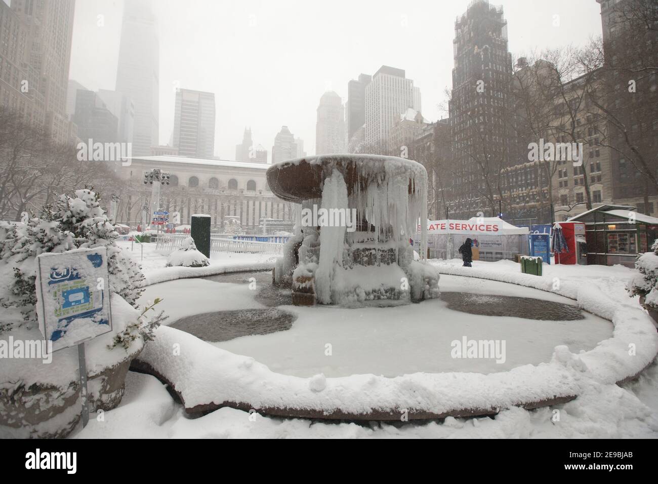 New York City USA Half Frozen Fountain at Bryant Park after snow storm ...