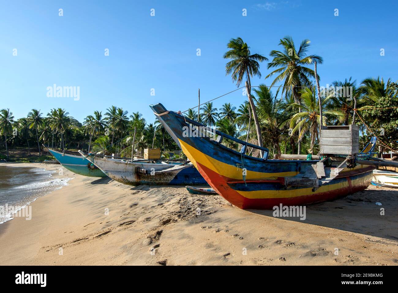 An Oruwa outrigger fishing boat sits adjacent to catamarans on Arugam ...