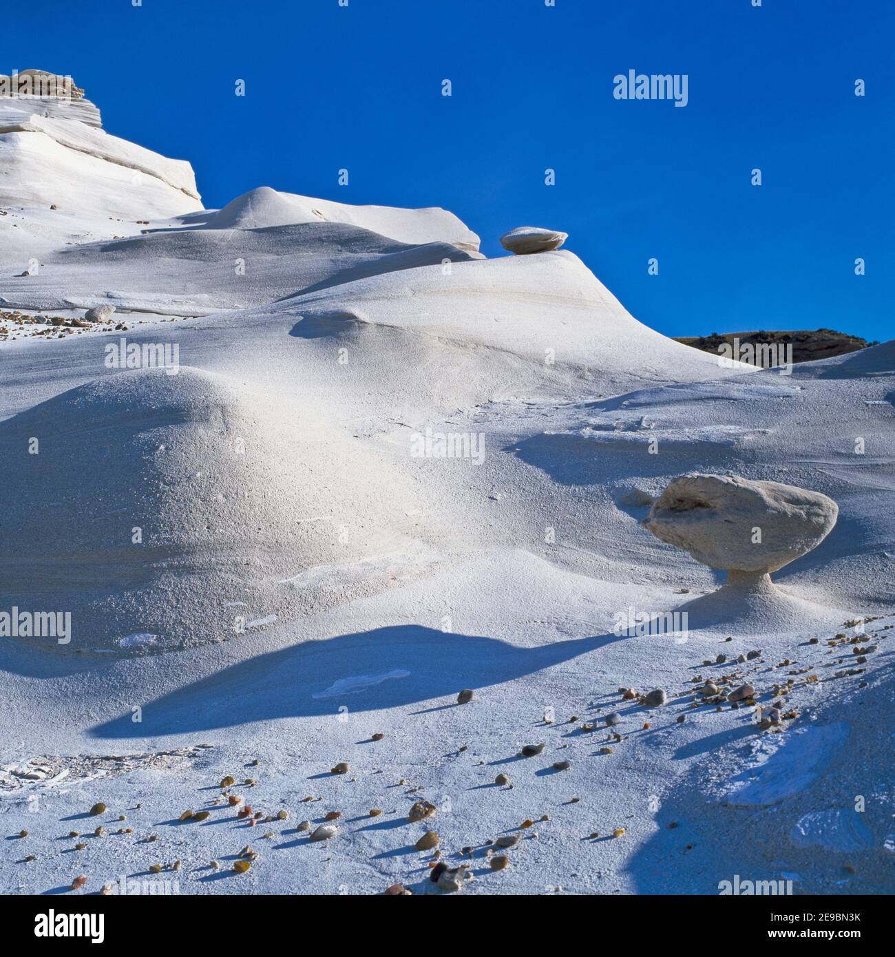 swirling mounds of eroded white volcanic ash and pumice in foothills of ...