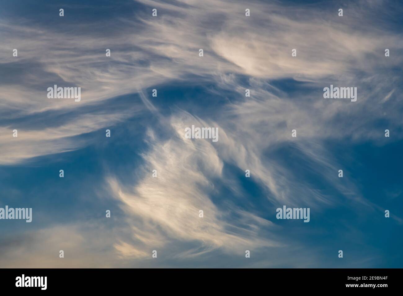 High clouds in the sky as sunset starts Stock Photo - Alamy