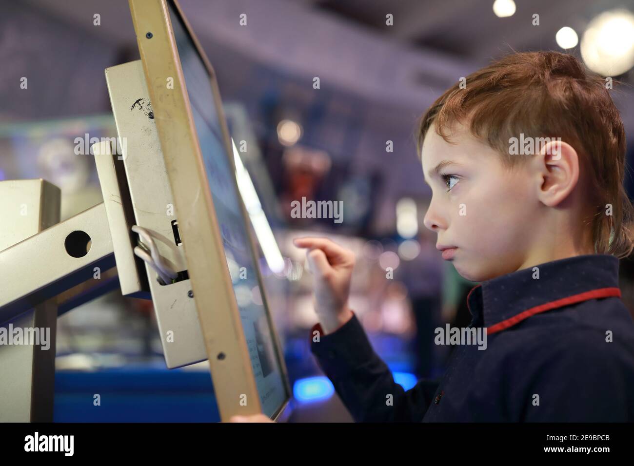 Boy using touch screen in a library Stock Photo - Alamy