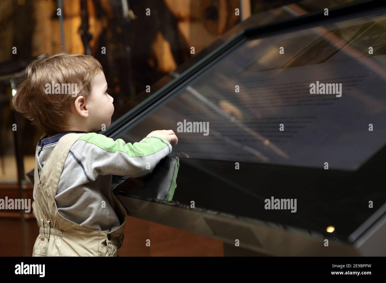 Boy learning touch screen in a museum Stock Photo - Alamy