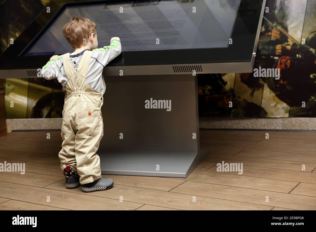 Child learning touch screen in a museum Stock Photo - Alamy