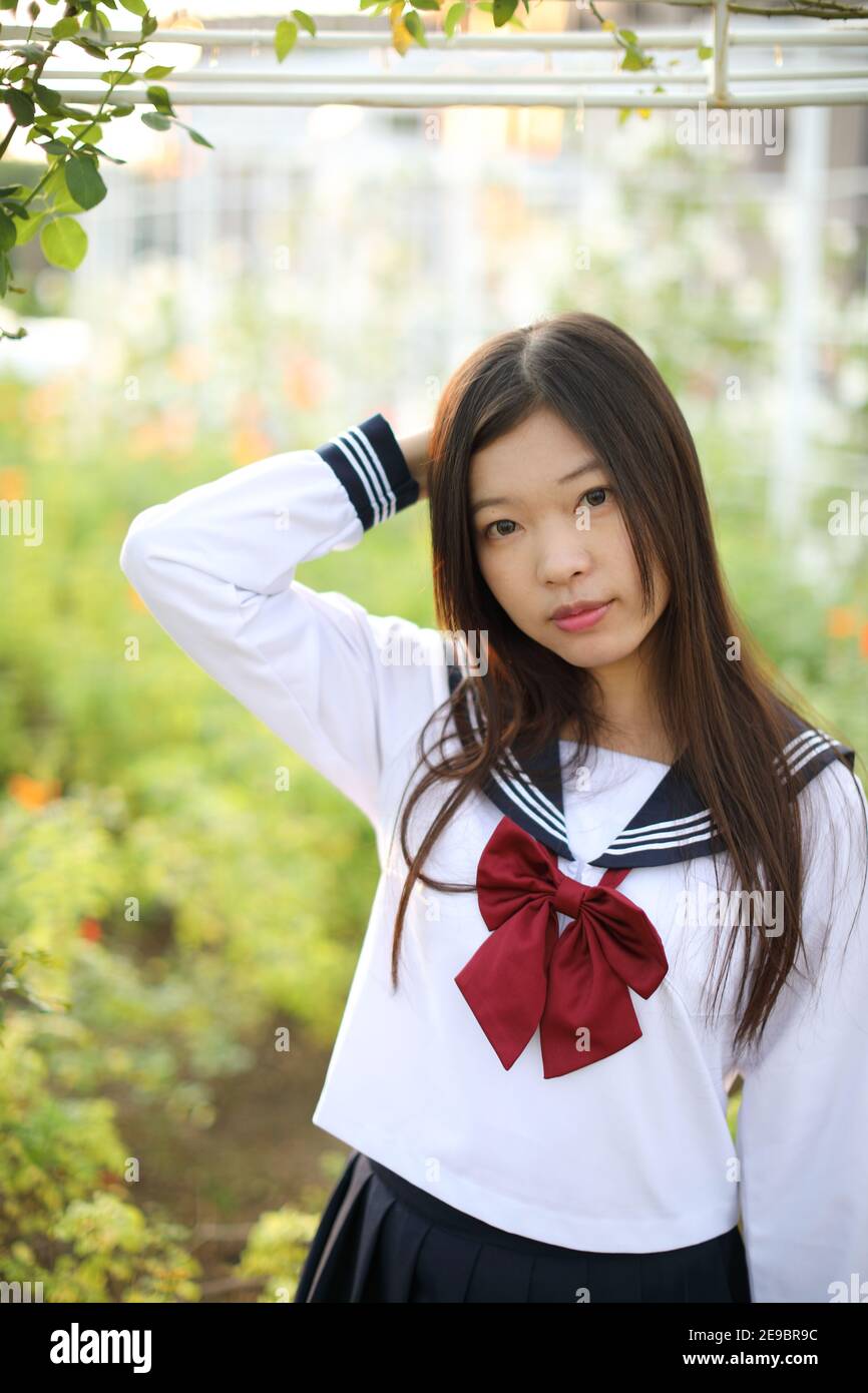 school girl costume at park outdoor with flowers garden background ...