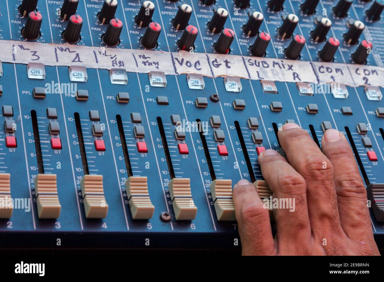 Audio mixing console closeup with hand Stock Photo - Alamy