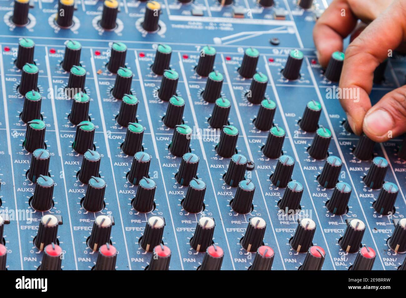 Audio mixing console closeup with hand Stock Photo - Alamy