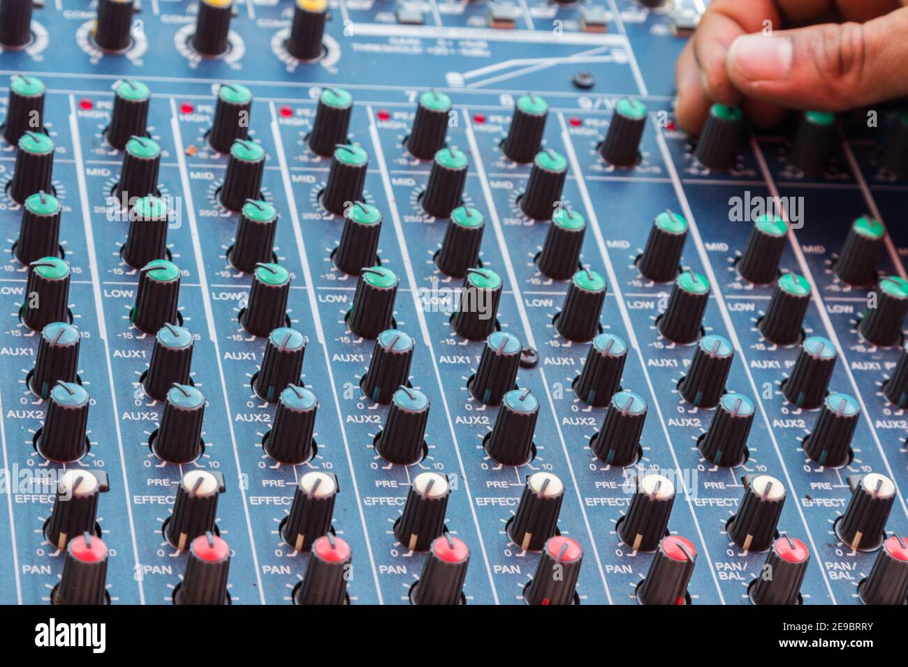 Audio mixing console closeup with hand Stock Photo - Alamy
