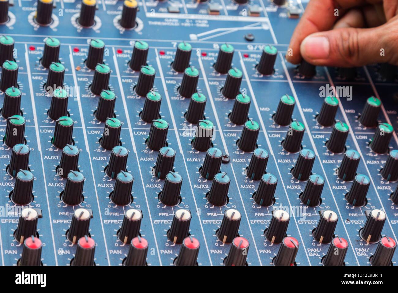 Audio mixing console closeup with hand Stock Photo - Alamy