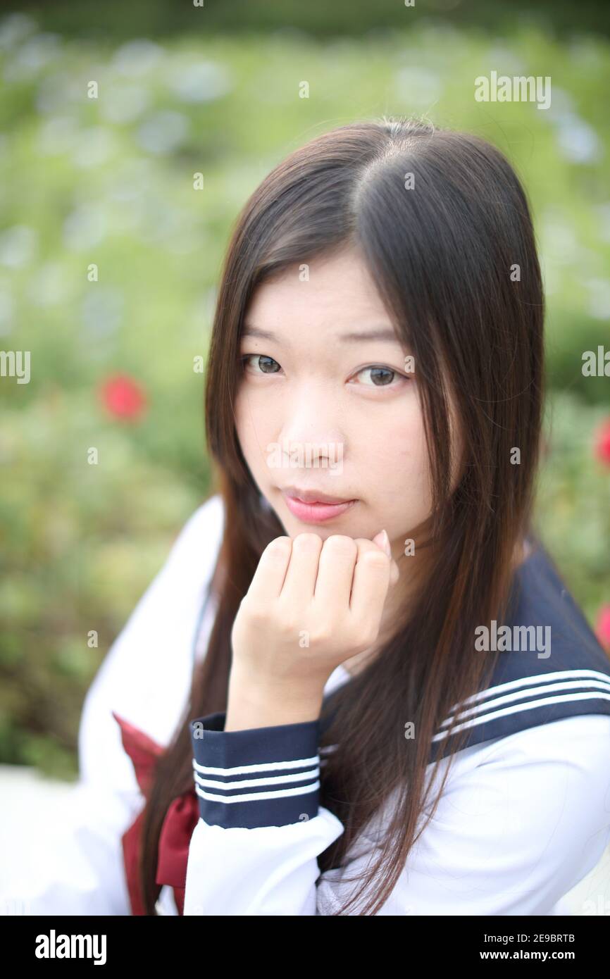school girl costume at park outdoor with flowers garden background ...