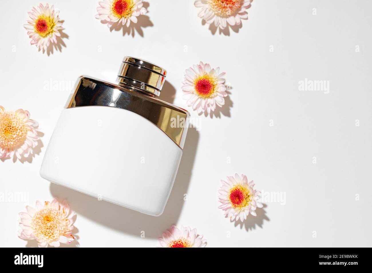 Bottle of fragrance surrounded by flower buds Stock Photo - Alamy