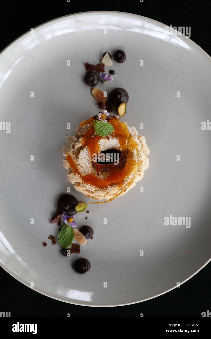 Chocolate dessert cake with berry sauce and almond with decorated Stock ...