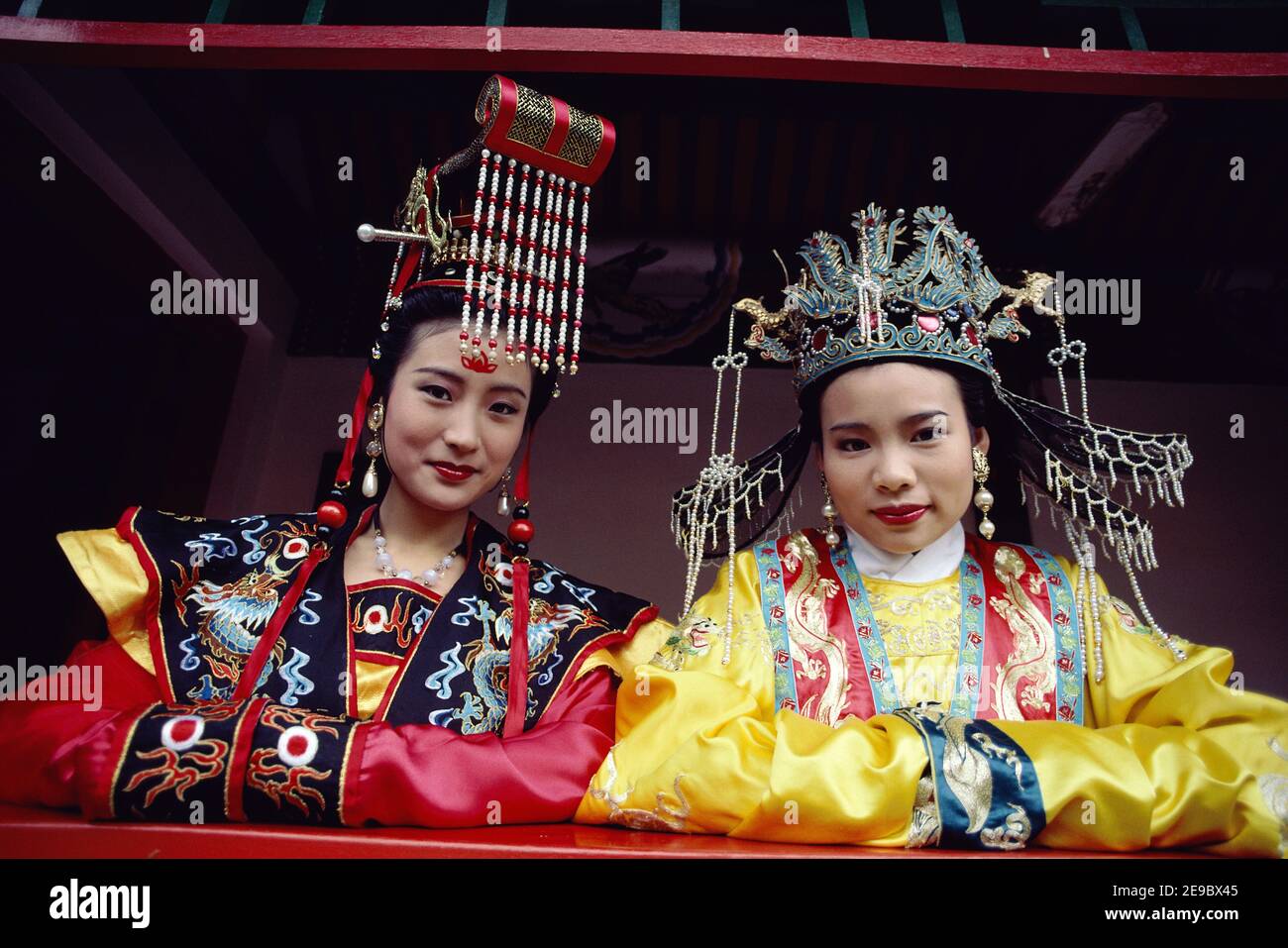 China, Hong Kong, two smiling Women Dressed in Traditional historical ...