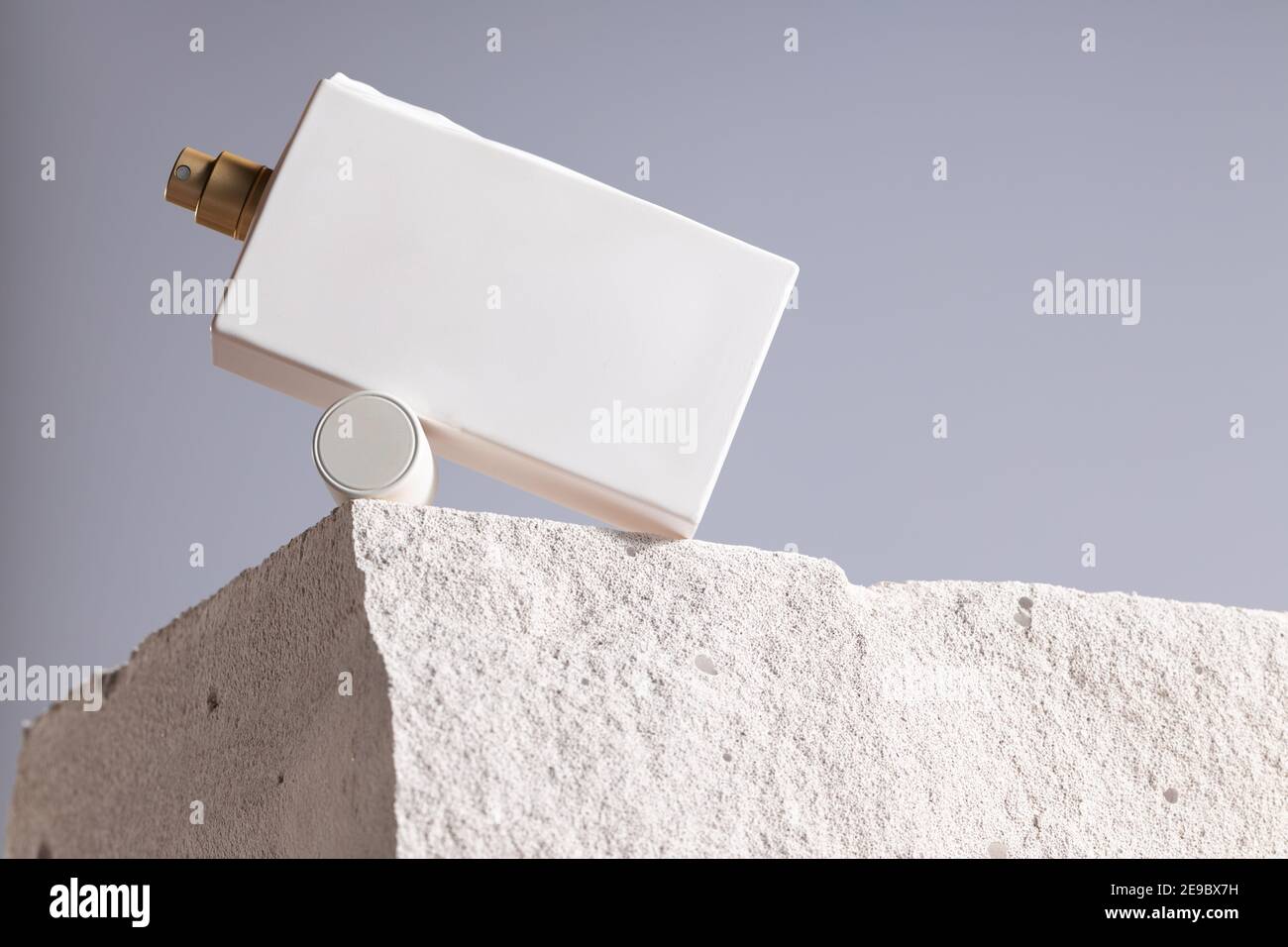 Bottle of perfume on cinder block close up Stock Photo - Alamy