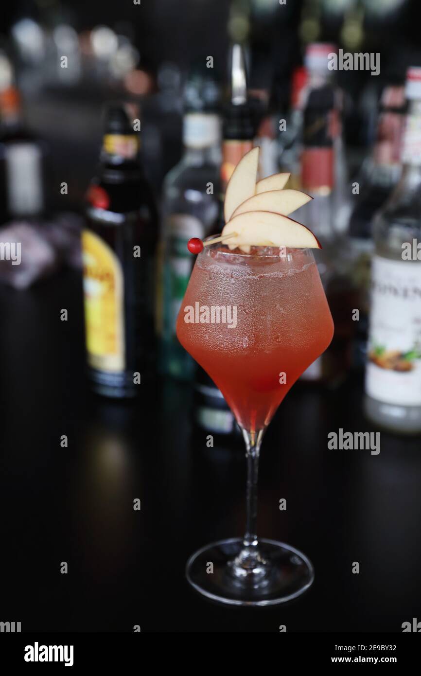 Pink Cocktail glass with ice at a bar counter Stock Photo - Alamy