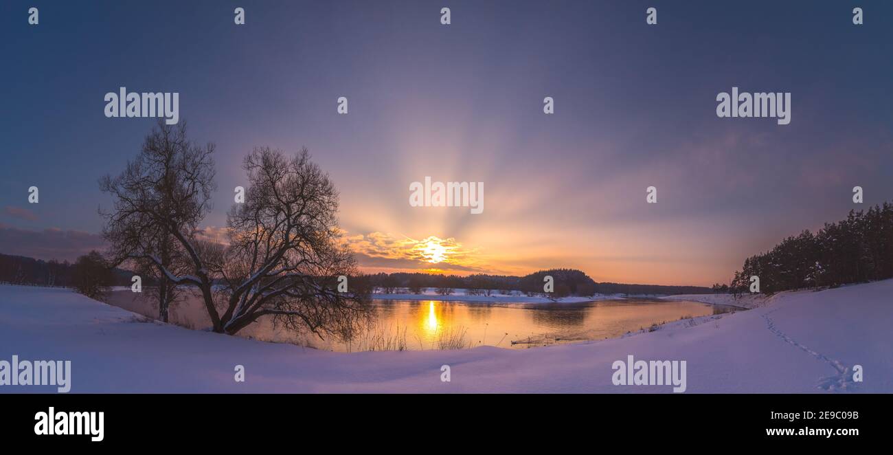 Winter evening landscape with sunrays in the sunset light Stock Photo ...