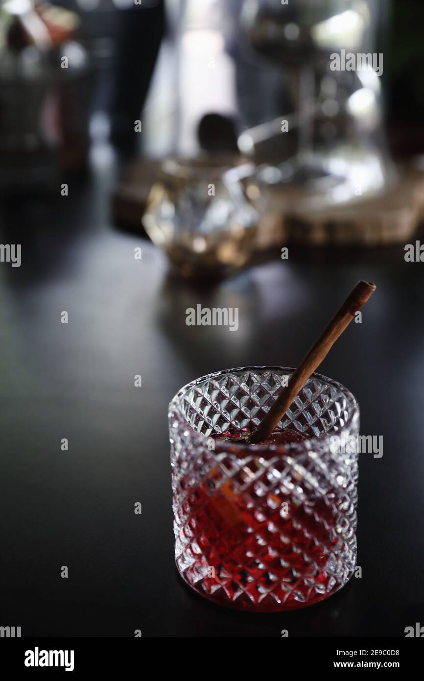 Pink Cocktail glass with ice at a bar counter Stock Photo - Alamy