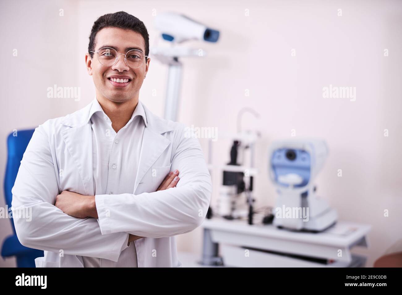 Smiling amicable ophthalmologist waiting for his patients Stock Photo ...