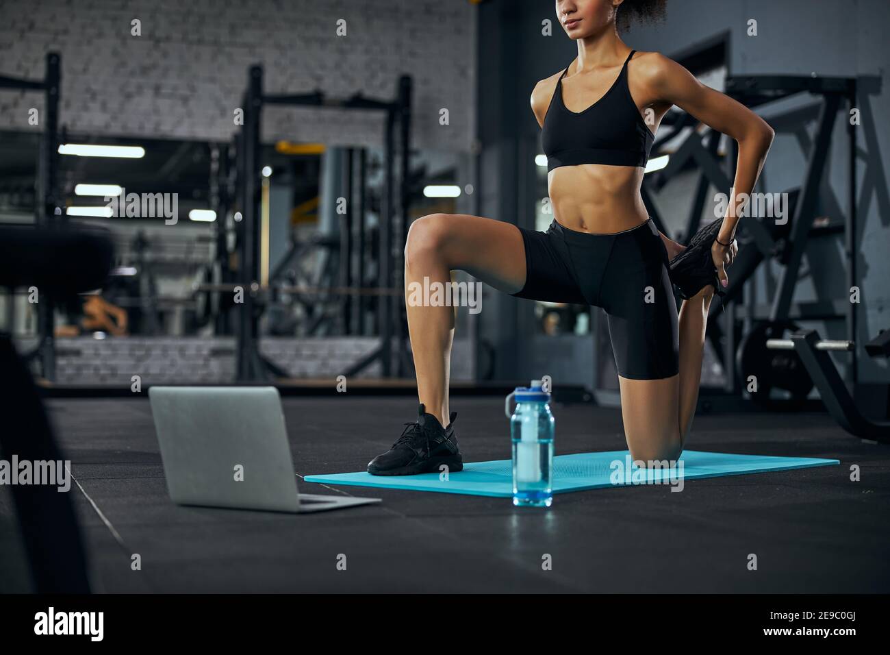 Focused woman stretching leg hi-res stock photography and images - Alamy