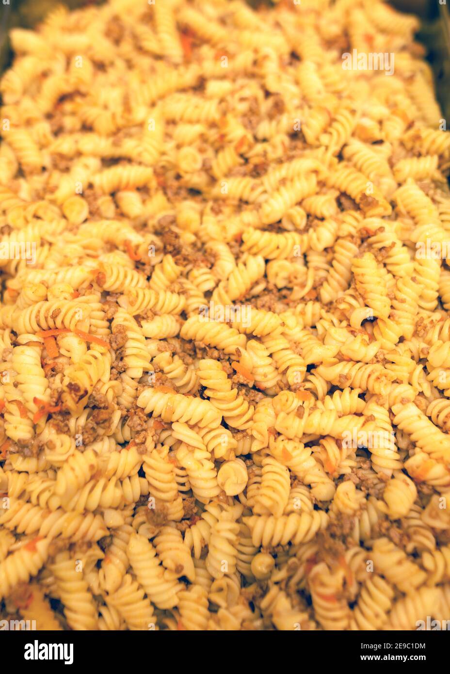 boiled pasta with meat and toppings in a metal pan, cooking, kitchen ...