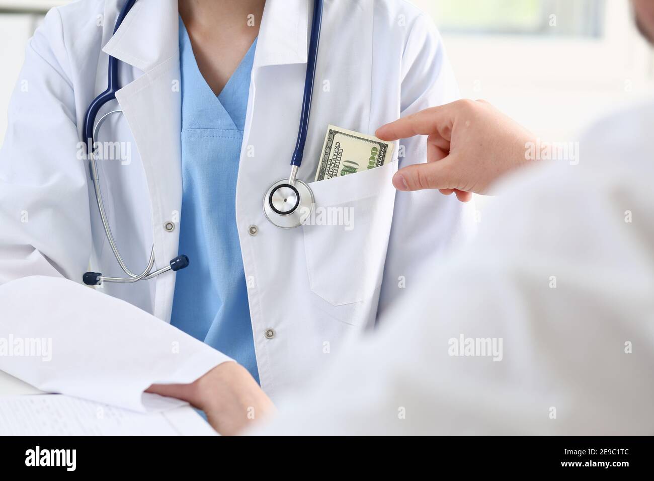 Female medicine doctor chest with bunch of hundred dollars bankn Stock ...
