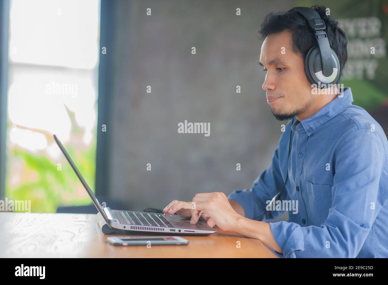 Asian man work call center support online working at home by laptop ...