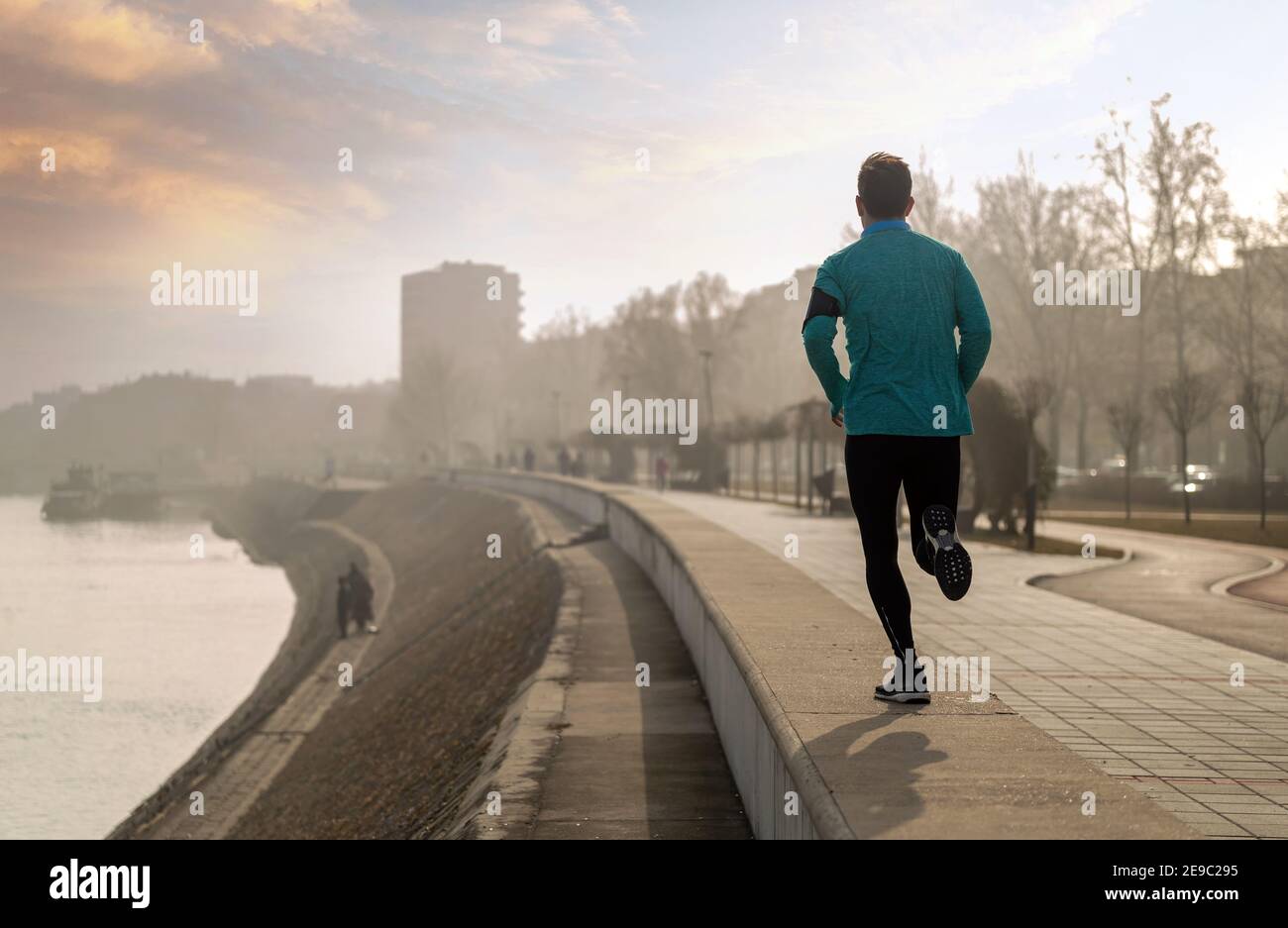 Young fitness man running in urban area Stock Photo - Alamy